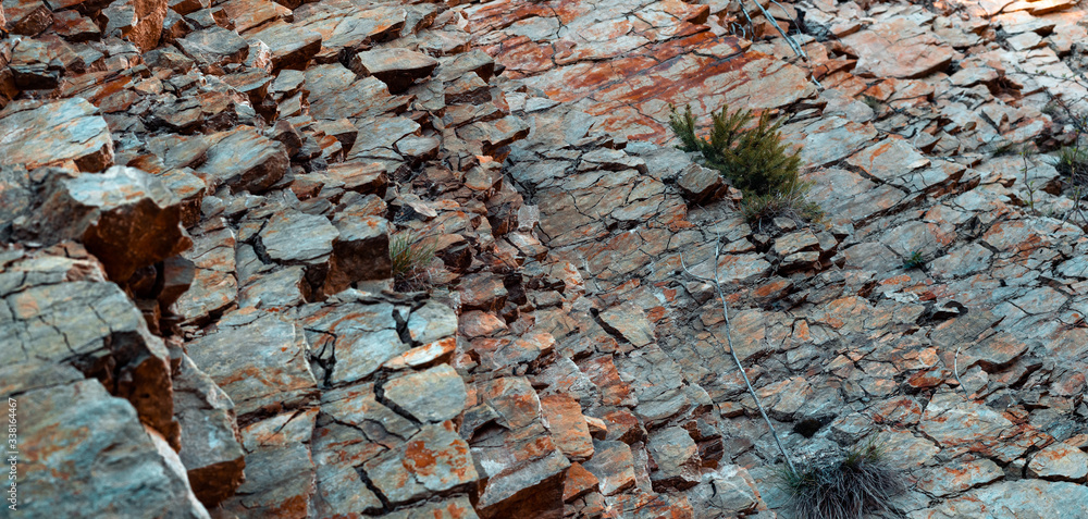 Natural basalt rock with cracks and crevices with a red color coming ...