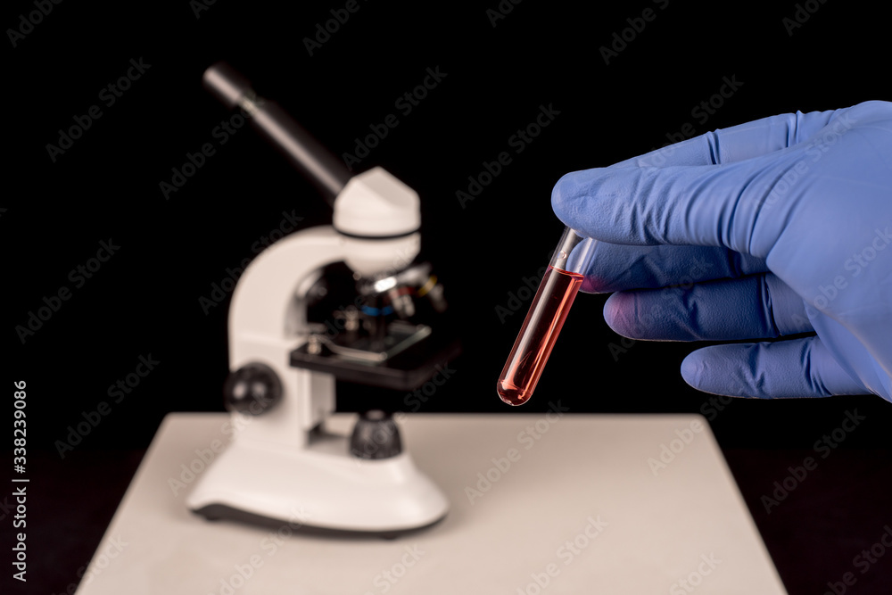 Photo & Art Print Microscope blurred and hand with surgical glove ...