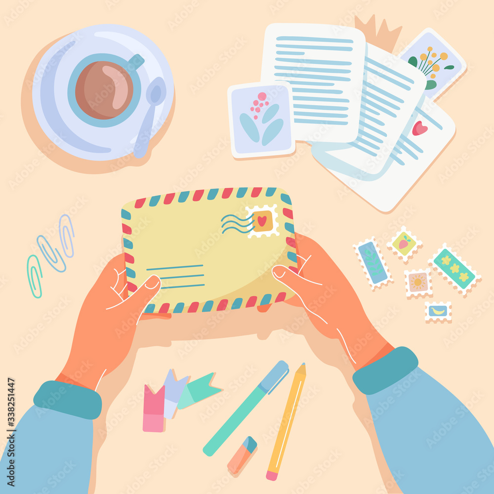 Female hands holding paper envelope. Post stamps, postcards, pens, cup ...