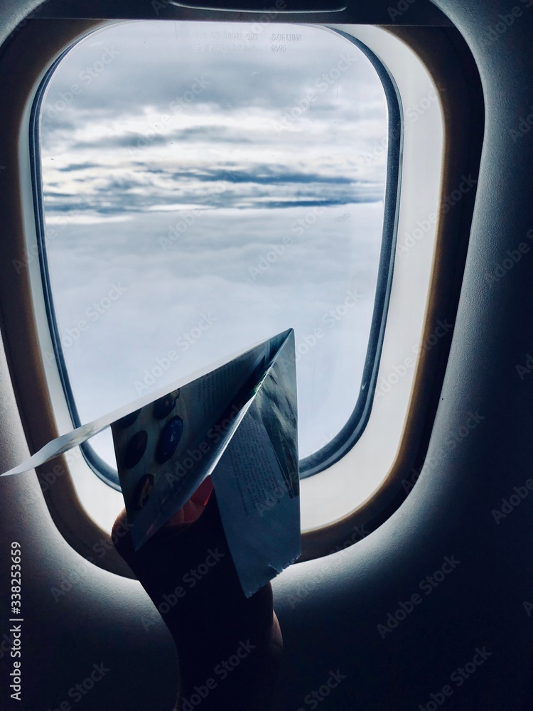 Cropped Hand Holding Paper Airplane By Window In Aircraft Stock Photo ...