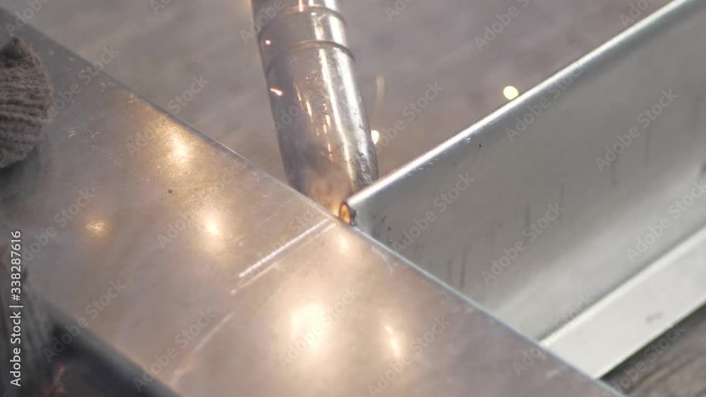 Welder works in metal construction - construction and processing of ...