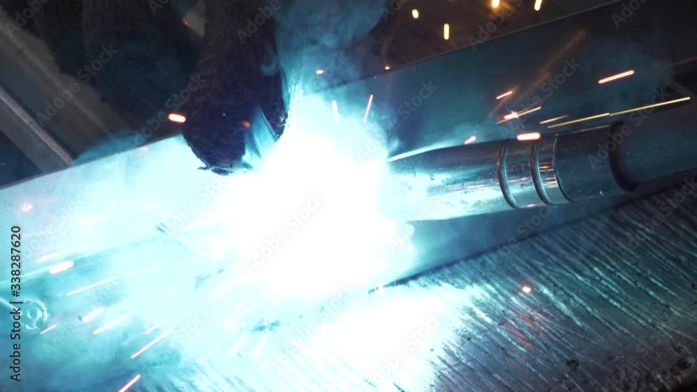 Welder works in metal construction - construction and processing of ...
