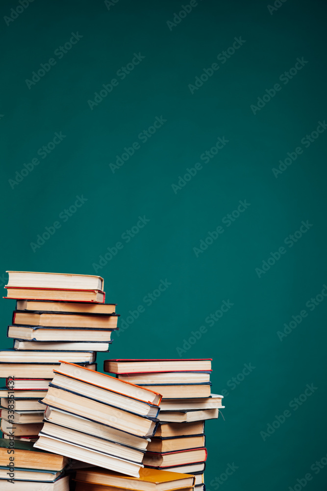 many stacks of educational books to teach in the school library on a ...