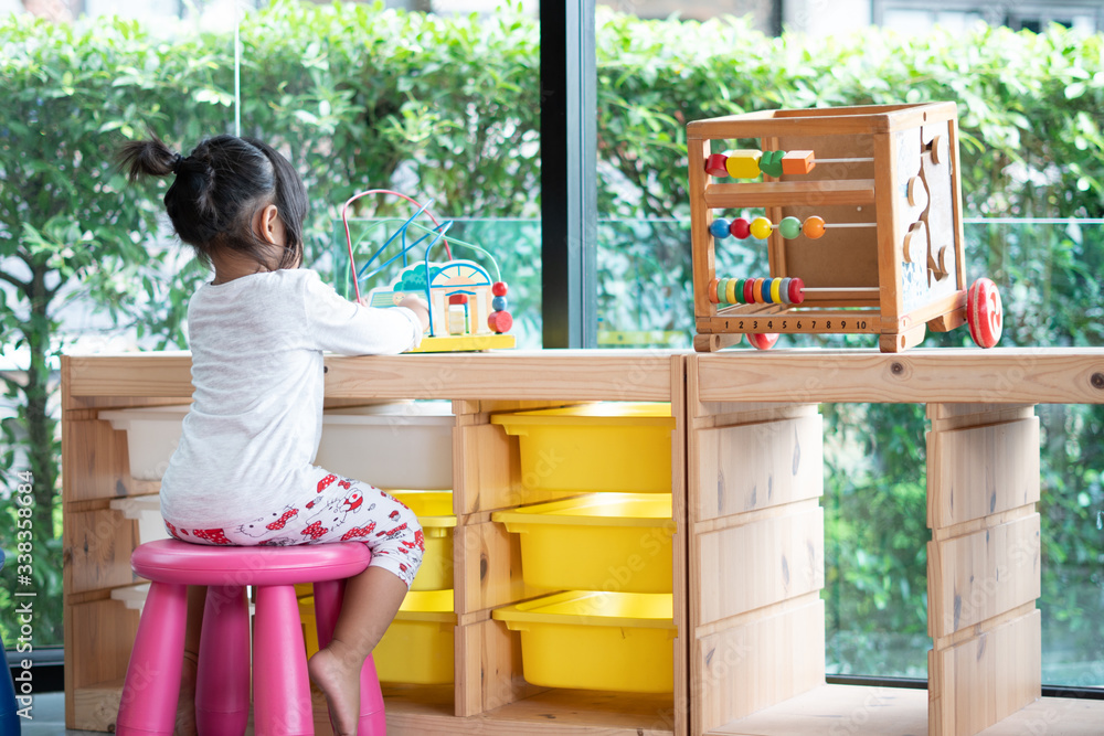 Kids learnfrom play with colourful wooden toy on table top at home ...