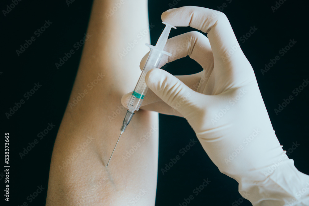 Nurse who is going to inject into the arm with a syringe. Drug or self ...