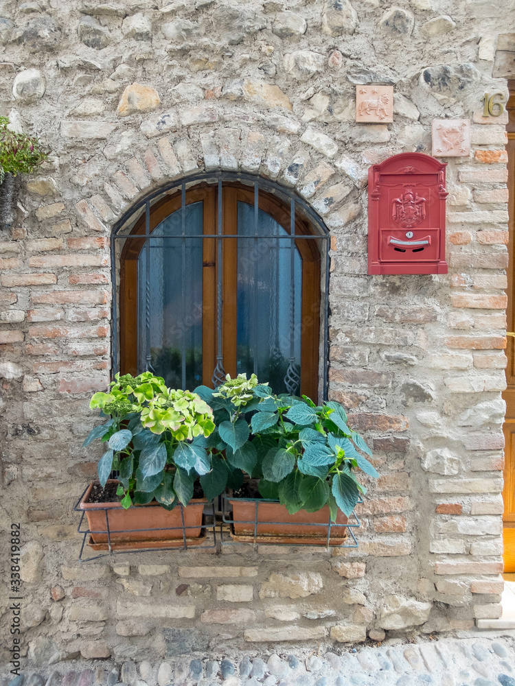 Picturesque window in a historic, restored castle complex in Italy. Two ...