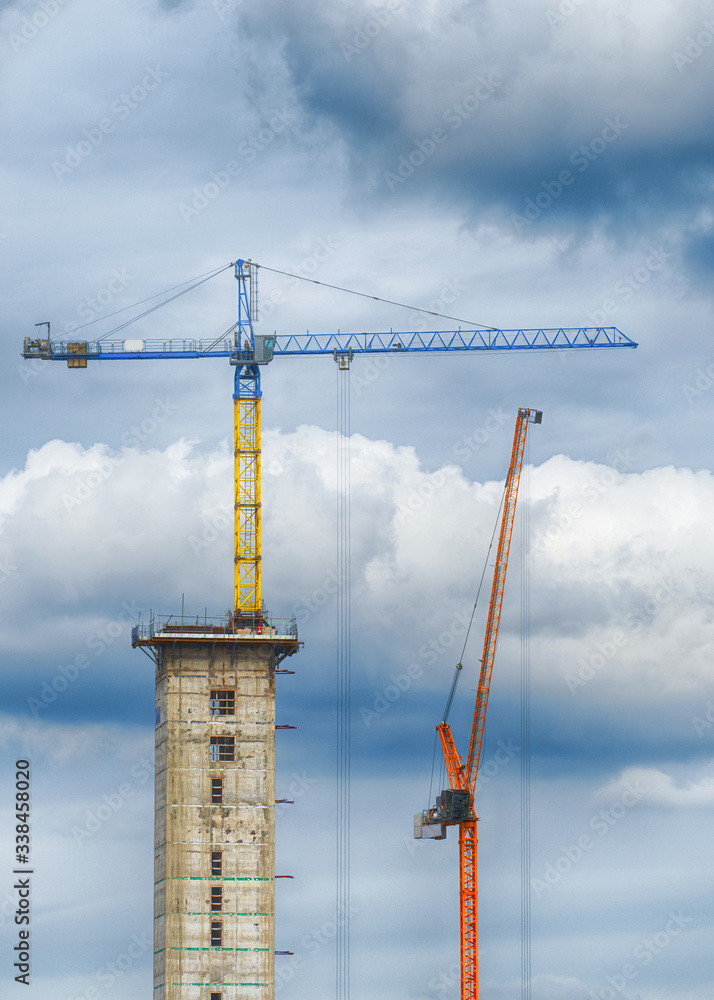 Two building working tower crane yellow and blue and orange for ...