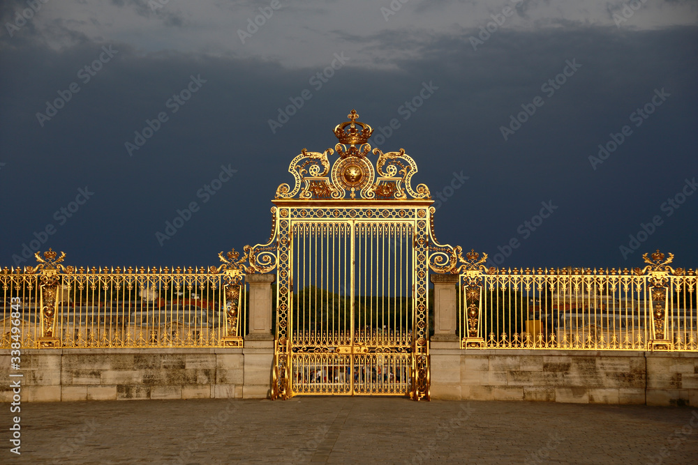 VERSAILLES, FRANCE - August 8, 2015: Main golden gates of the chateau ...