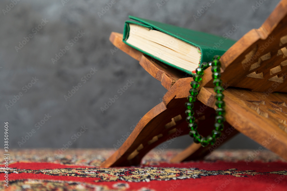 Quran and rosary beads on the white background with blue candle for ...