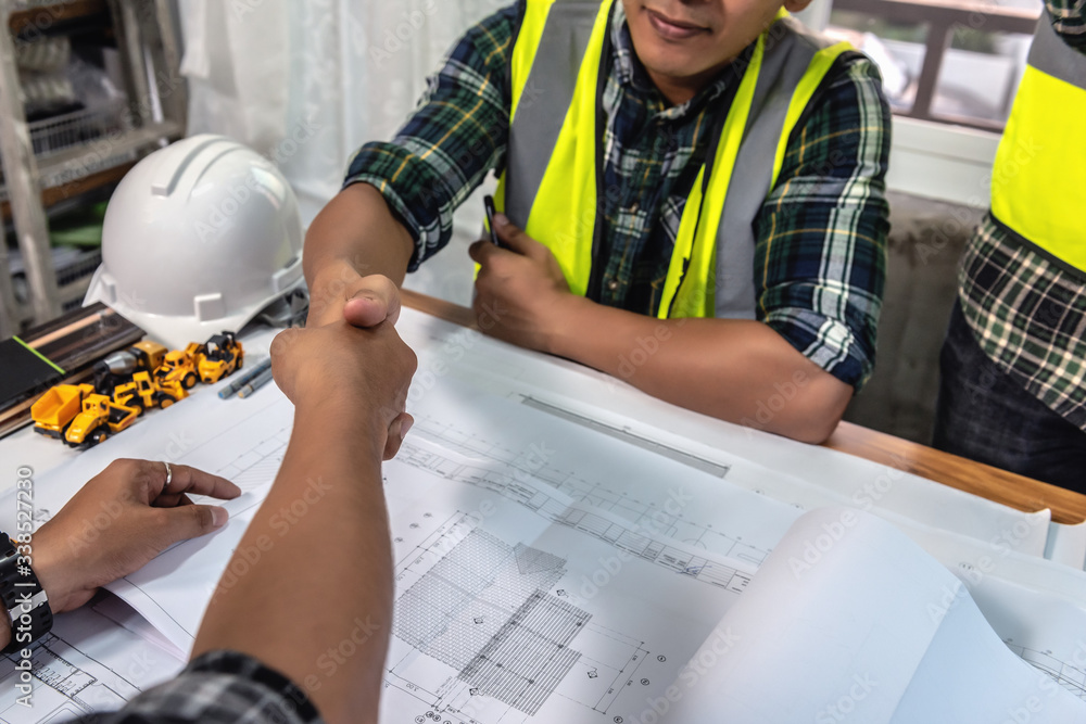 Engineer designer and Architect people shaking hands in the office for ...