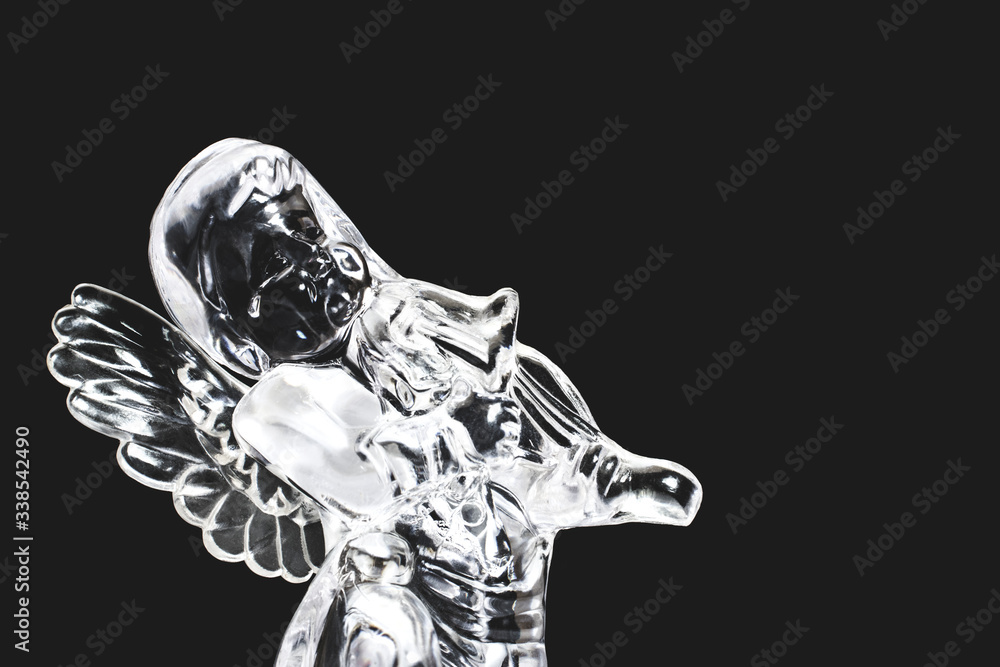 White angel on a black background with space for copy space. The photo ...