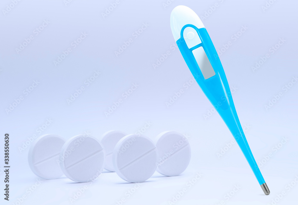 Blue digital thermometer with empty screen and pills on white ...
