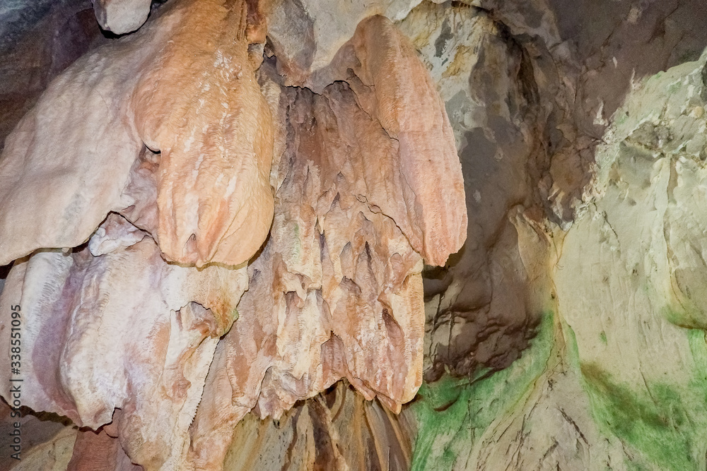 tourist cave .High arches of a huge stone cave with round holes at the ...