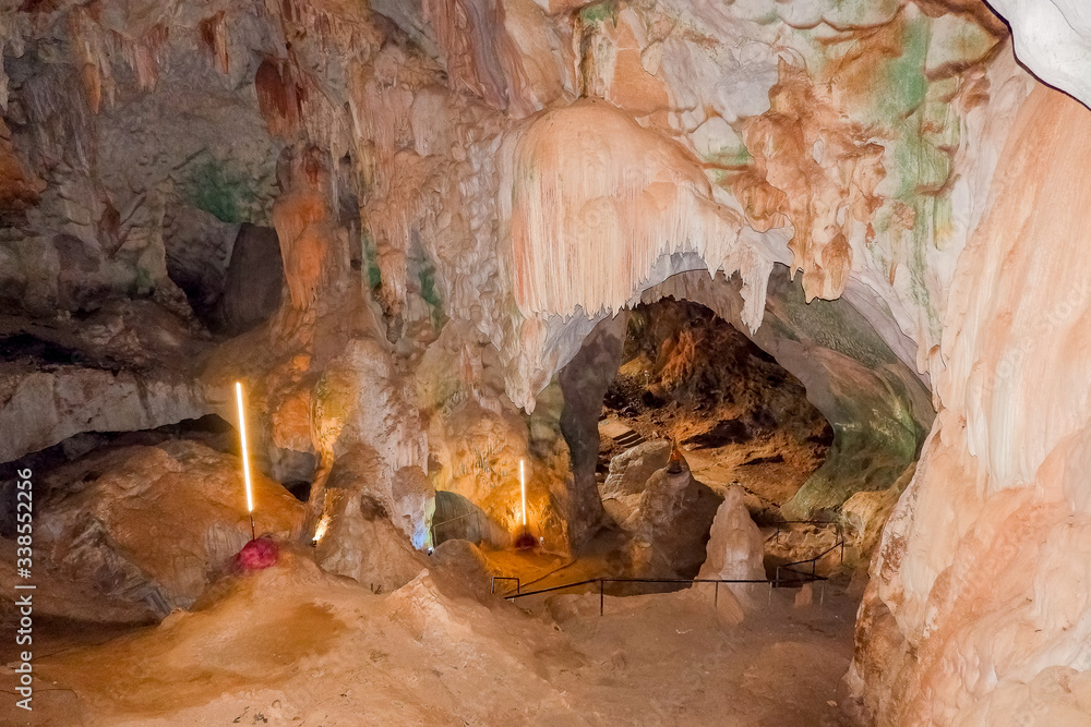 tourist cave .High arches of a huge stone cave with round holes at the ...