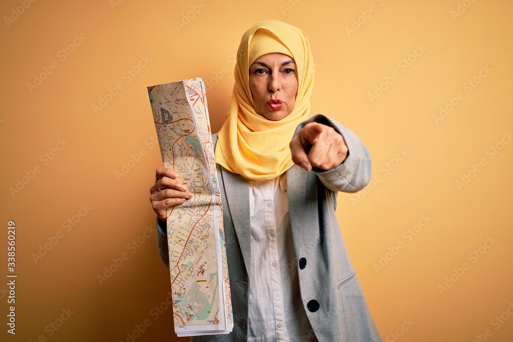 Middle age brunette tourist woman wearing traditional muslim hijab ...