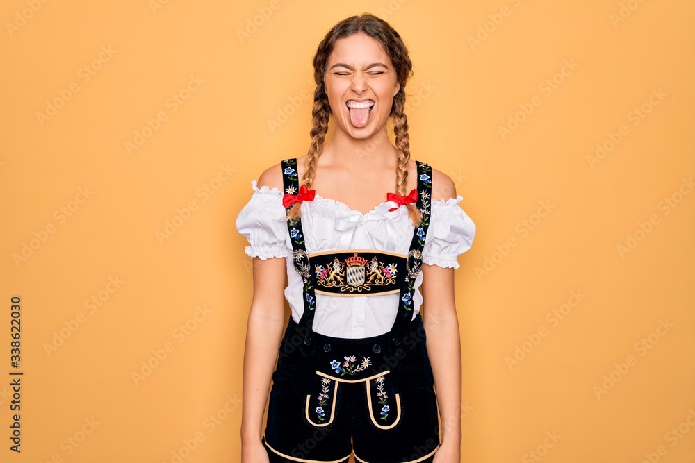 Young beautiful blonde german woman with blue eyes wearing traditional ...