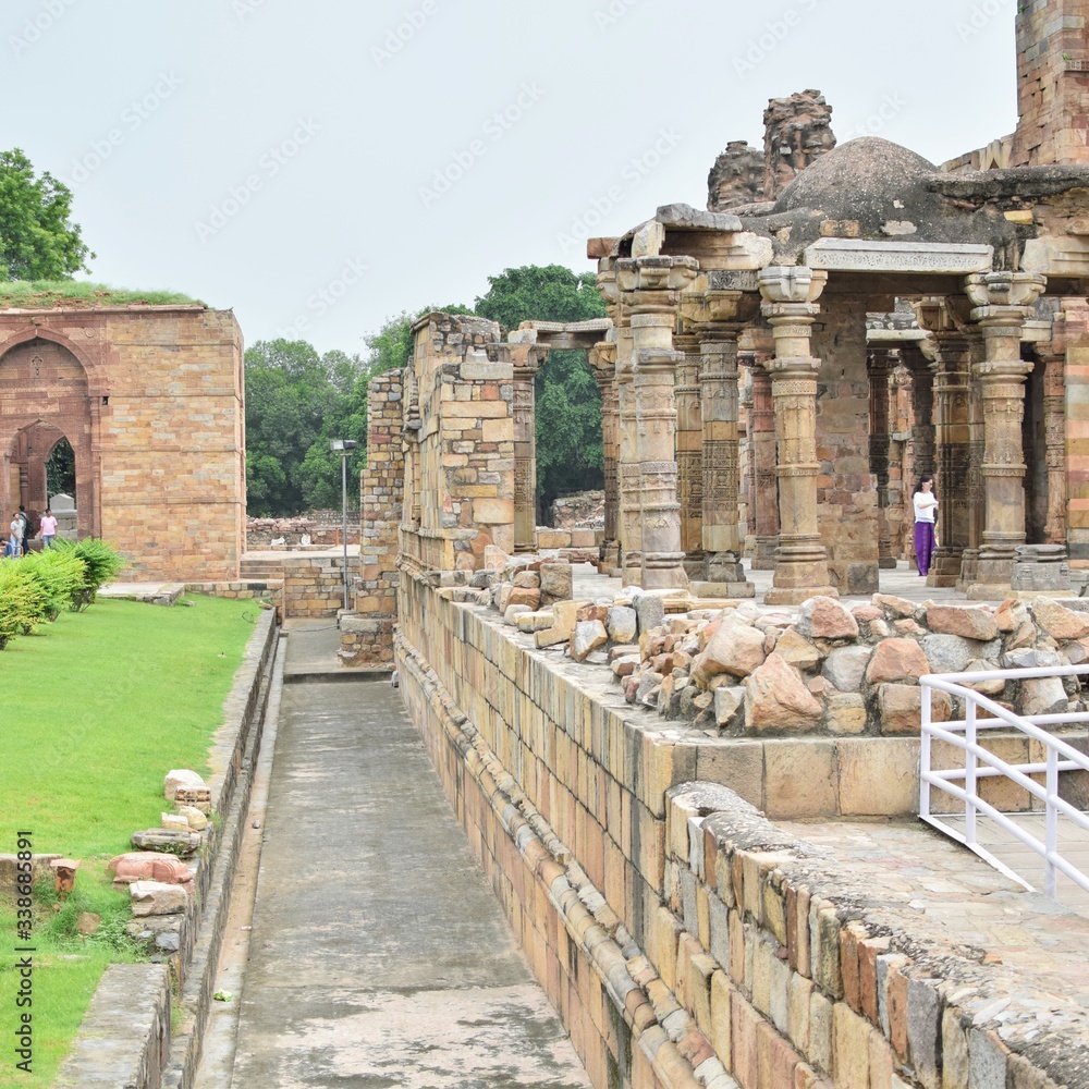 Inside the Qutub Minar Complex with antic ruins and inner square ...