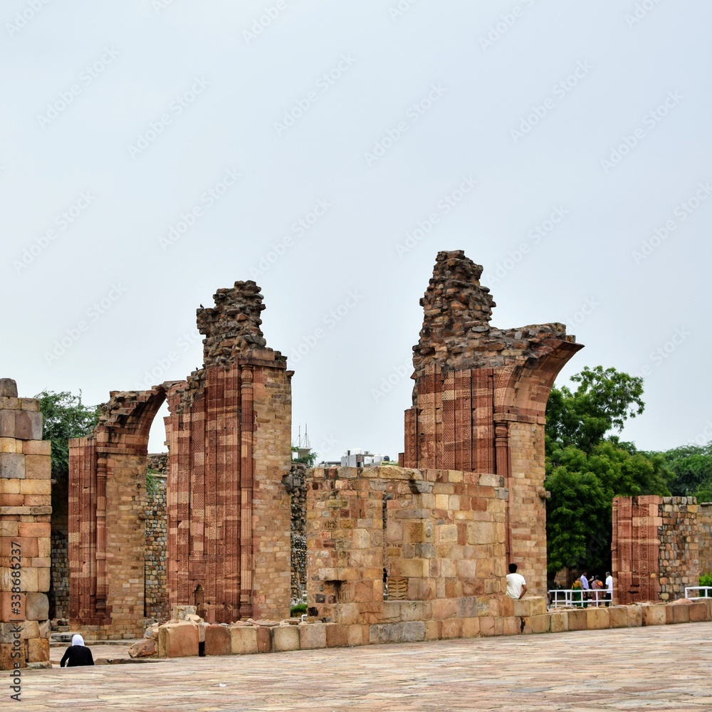 Inside the Qutub Minar Complex with antic ruins and inner square ...