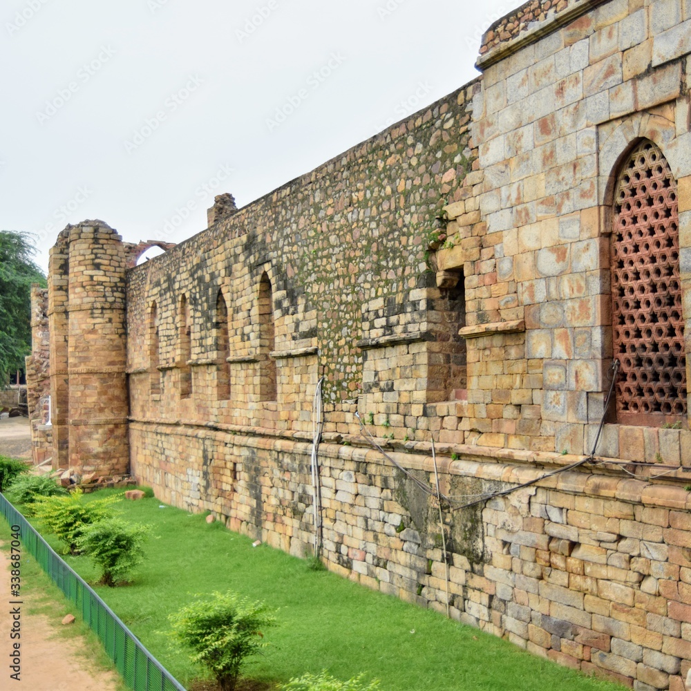 Inside the Qutub Minar Complex with antic ruins and inner square ...