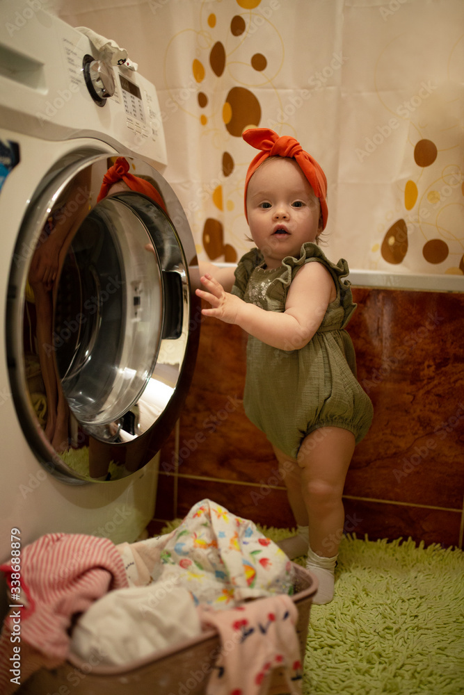 Little girl and a washing machine Stock Photo | Adobe Stock