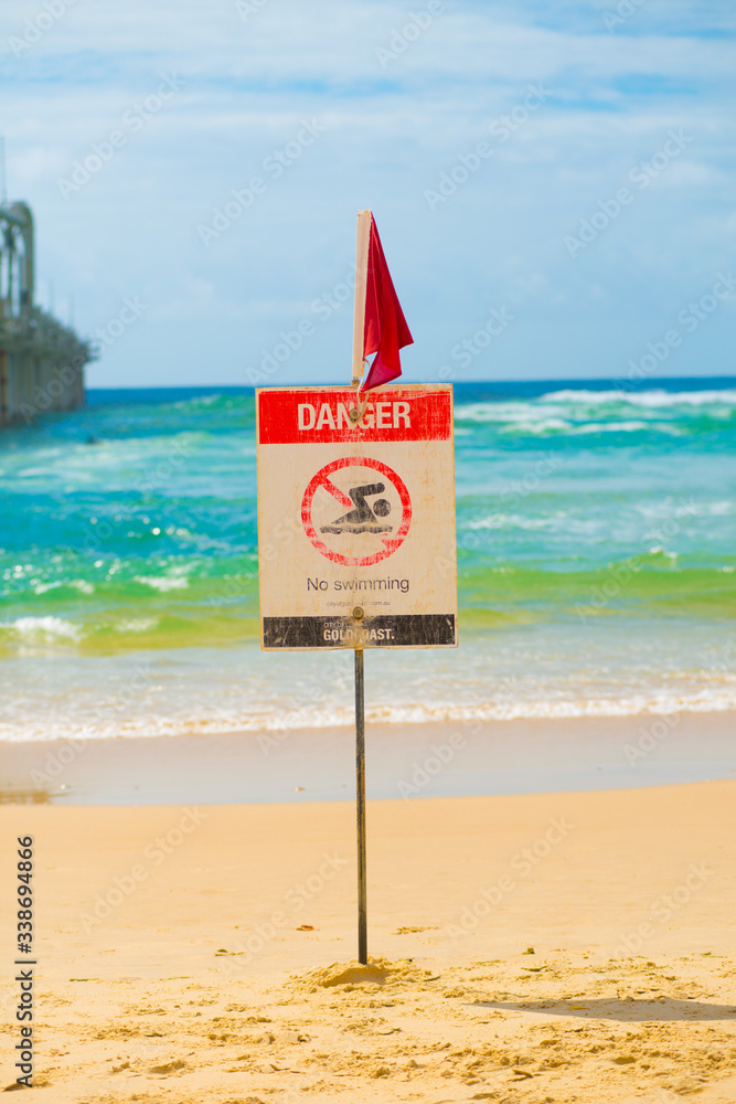 Sign says ''No swimming'' at the beach of Gold Coast, Australia ...