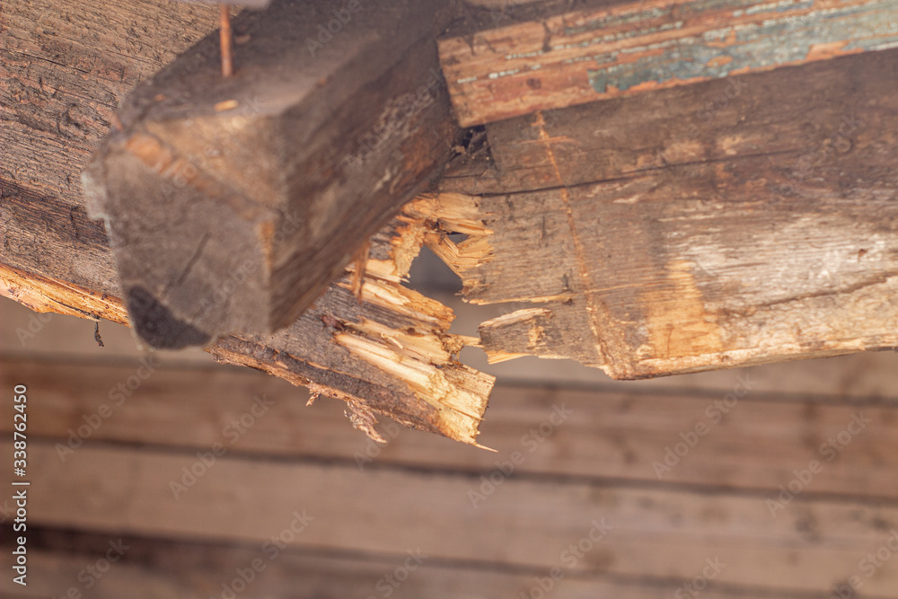 Broken wooden beam of the canopy. wooden roof of a barn destroyed due ...