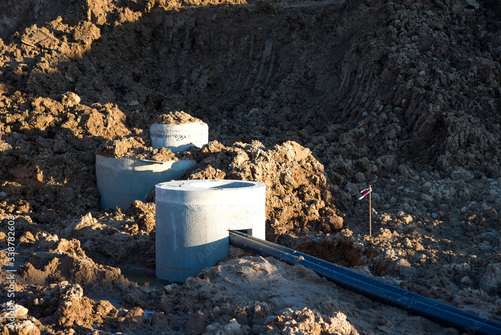 Laying concrete manholes and drain pipes for stormwater system ...