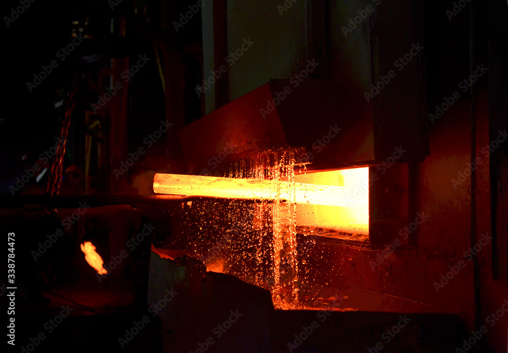Steel quenching at high temperature in industrial furnace at the ...