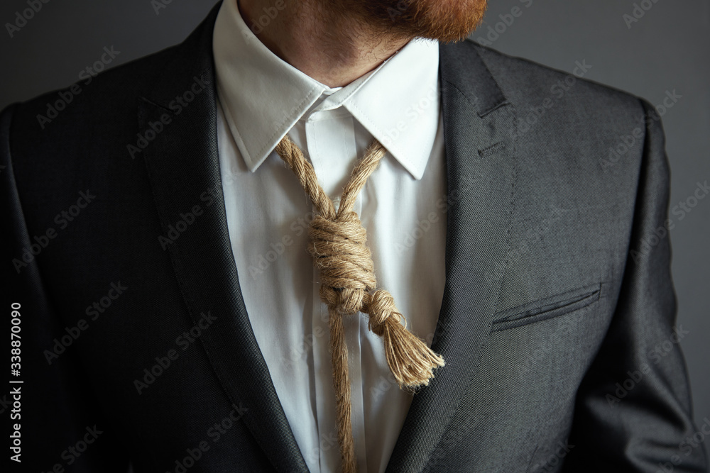 Concept image of business in trouble. Man in suit with Lynch loop ...