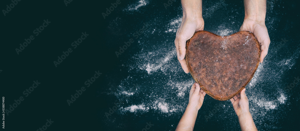 father baker gives rye whole grain yeast-free sourdough bread in shape ...