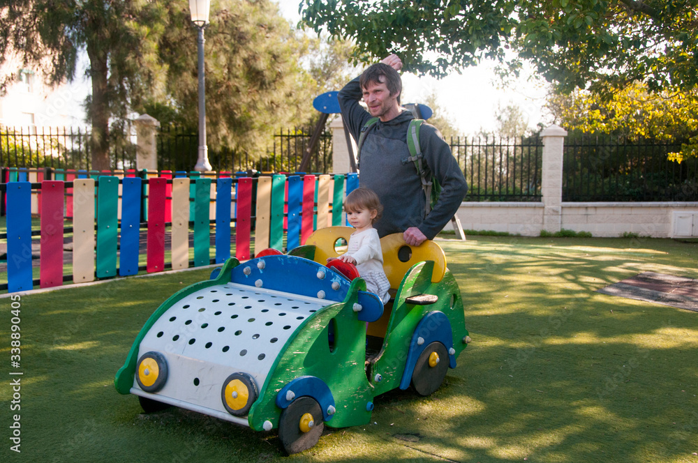 Little girl and her father having fun on a kids playground. Baby ...