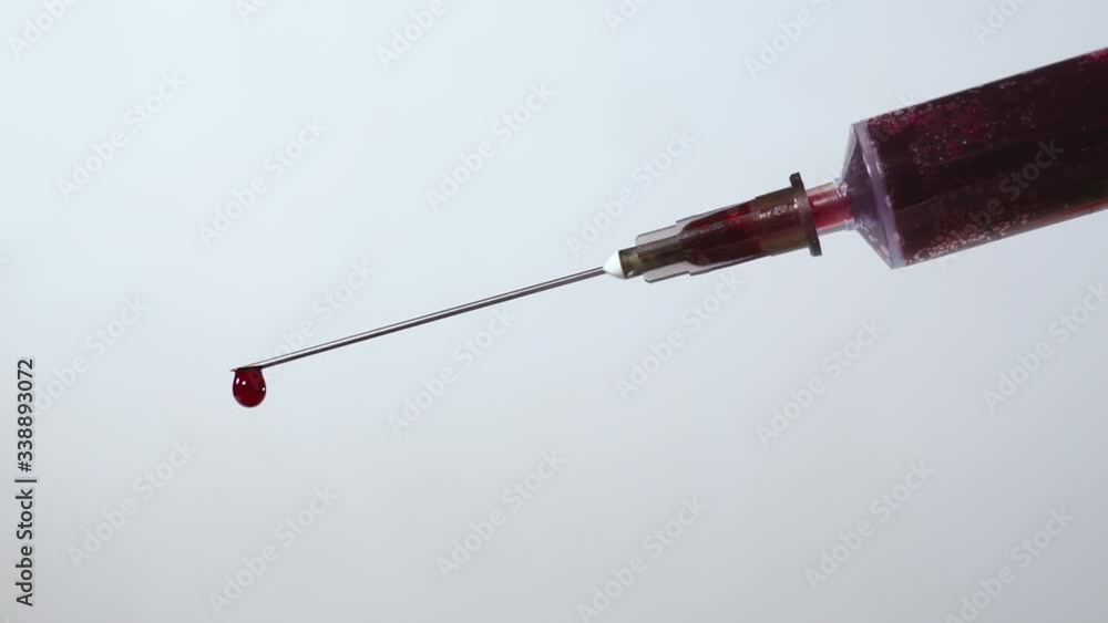 Medical syringe with blood isolated on white background. Blood drops ...