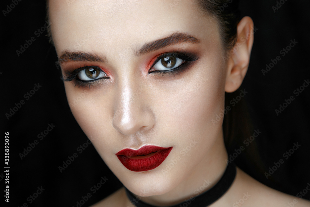 Close-up portrait of gorgeous young woman with red lips and bright ...