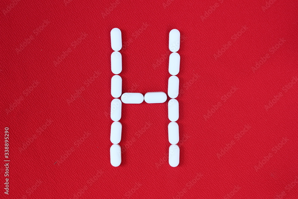 Alphabet made of pills on a red background. Abc from drugs. Letter H ...