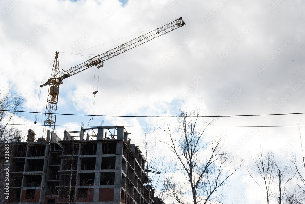 Tower crane builds a new house from a monolithic frame and a monolithic ...