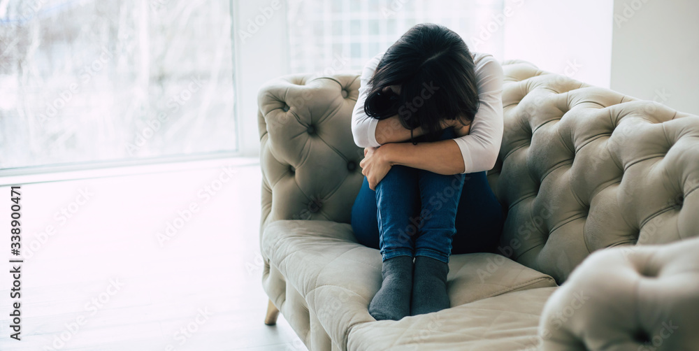 Struggling alone. Close-up photo of a lonely woman who is sitting on ...