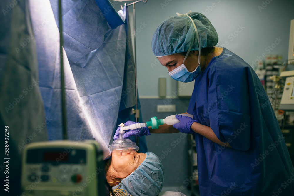 Doctor putting anesthesia mask to patient in operating room Stock Photo ...