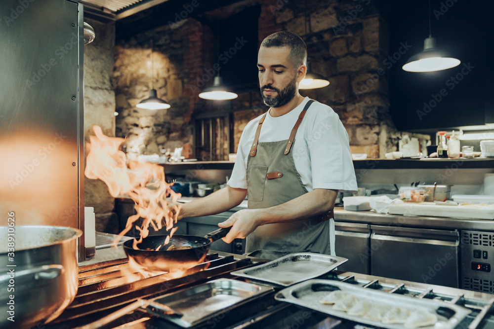 Chef preparing food in restaurant kitchen Stock Photo | Adobe Stock