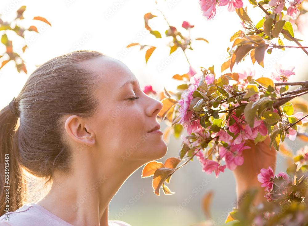 Girl smelling blooming tree Stock Photo | Adobe Stock
