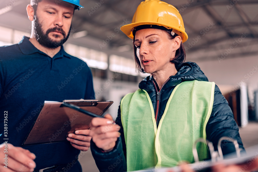 Workplace safety inspector writing a report at industrial factory Stock ...