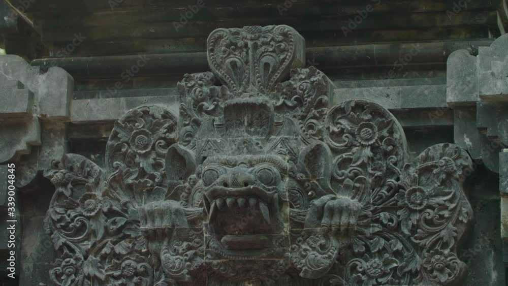 Beautiful sandstone carving of a demon head in a hindu temple in Bali ...