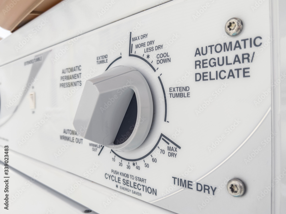 knob on a clothing dryer control panel Stock 写真 | Adobe Stock