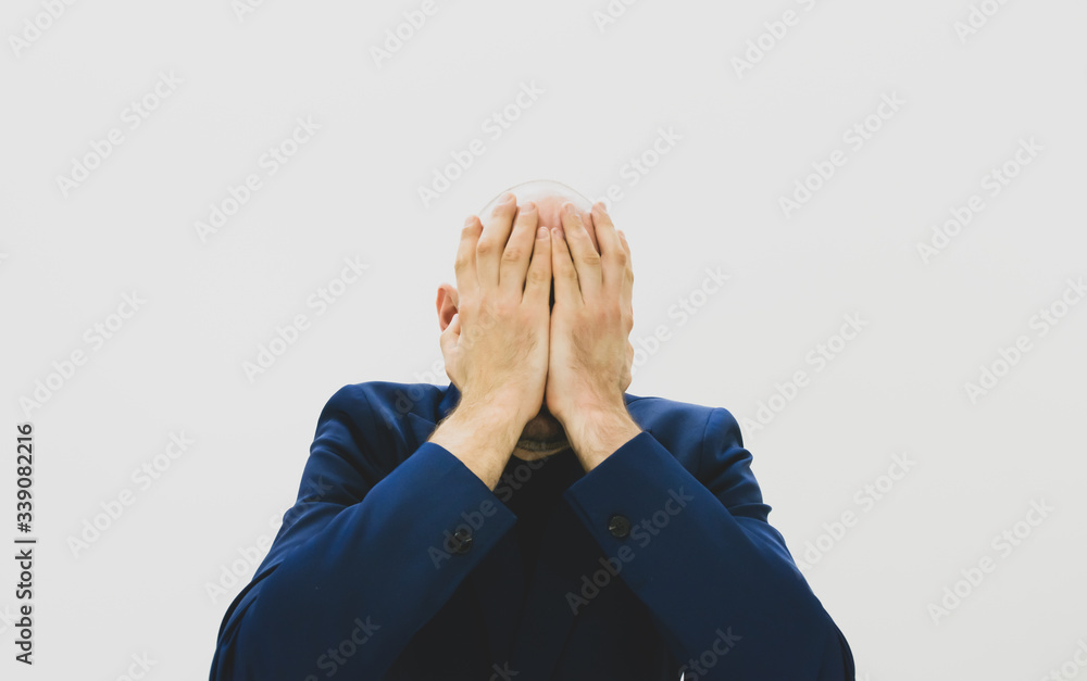 Male person in blue suit is covering his red face out of shame and ...