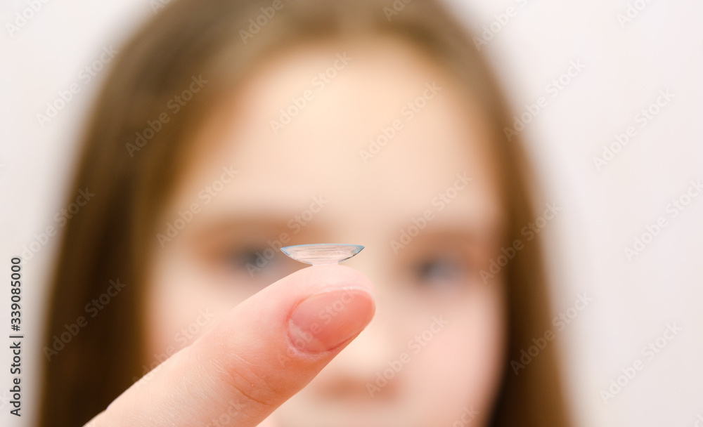 Little girl child putting contact lens into her eye closeup Stock Photo ...