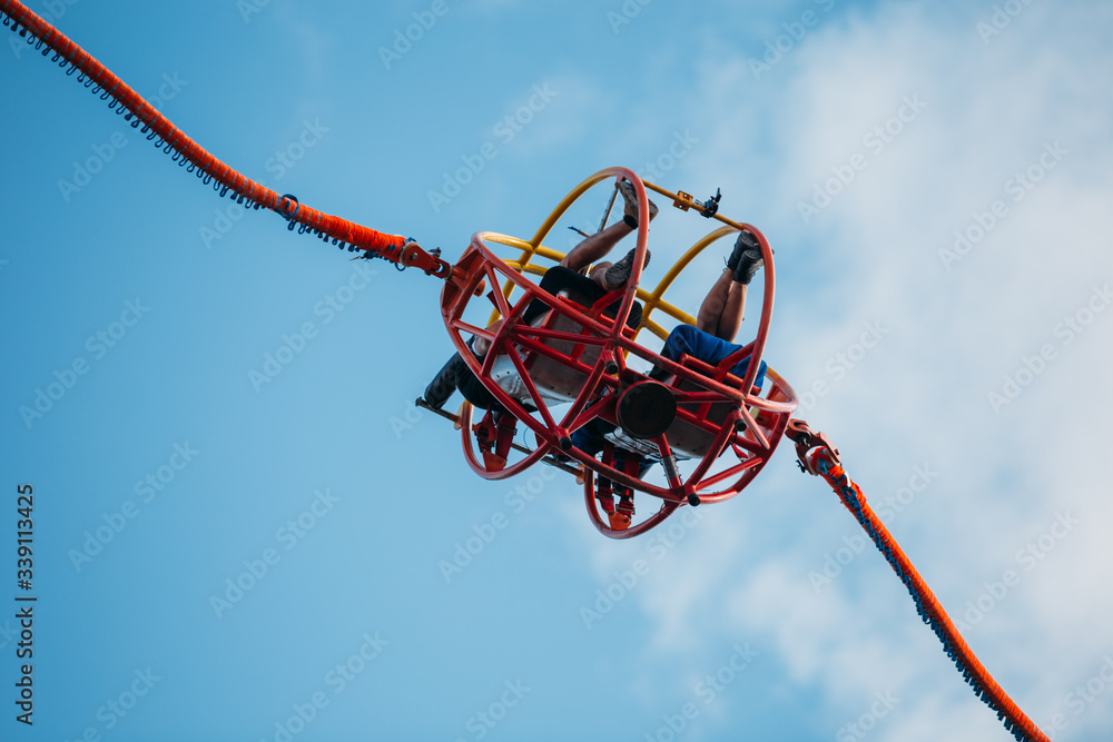 People having fun on a reversed bungee, also called slingshot ride ...