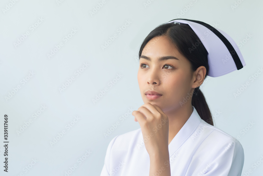 portrait of asian woman nurse looking up isolated, confident serious ...