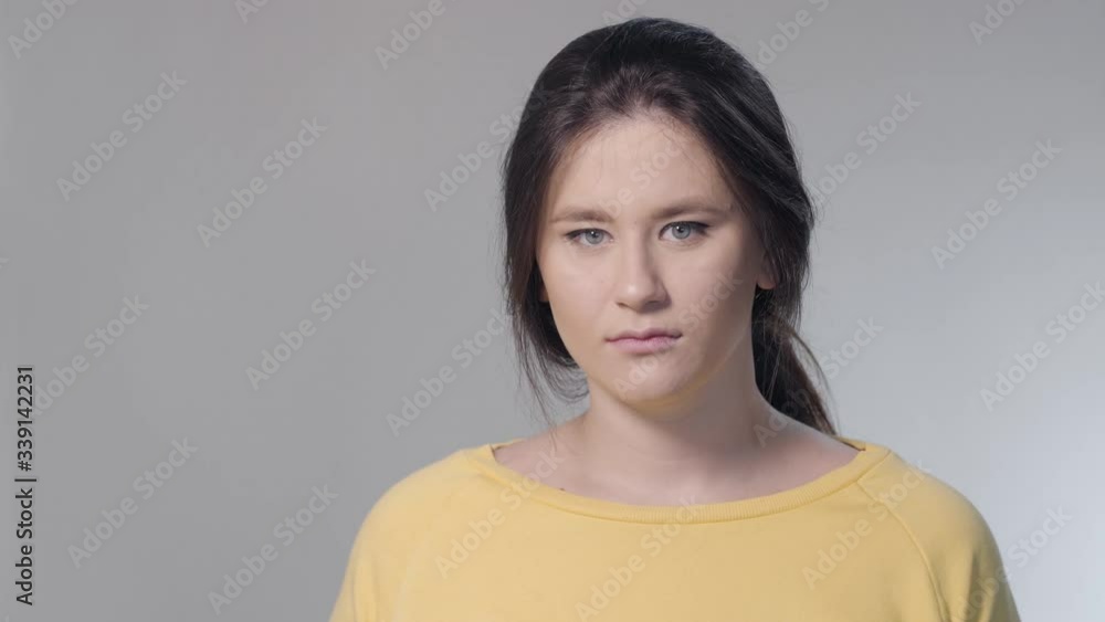 Close-up face of displeased Caucasian woman turning to camera and ...