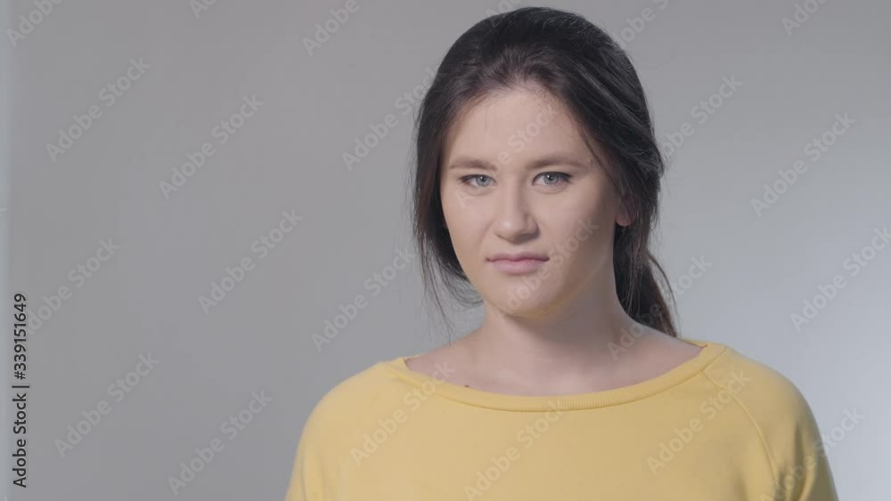 Portrait of young woman with face of contempt. Brunette Caucasian girl ...