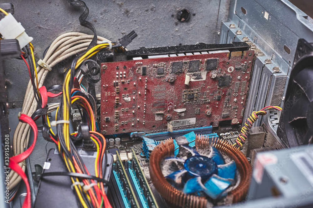 Dust on the cooler of a laptop computer processor with a motherboard and a fragment of a ...