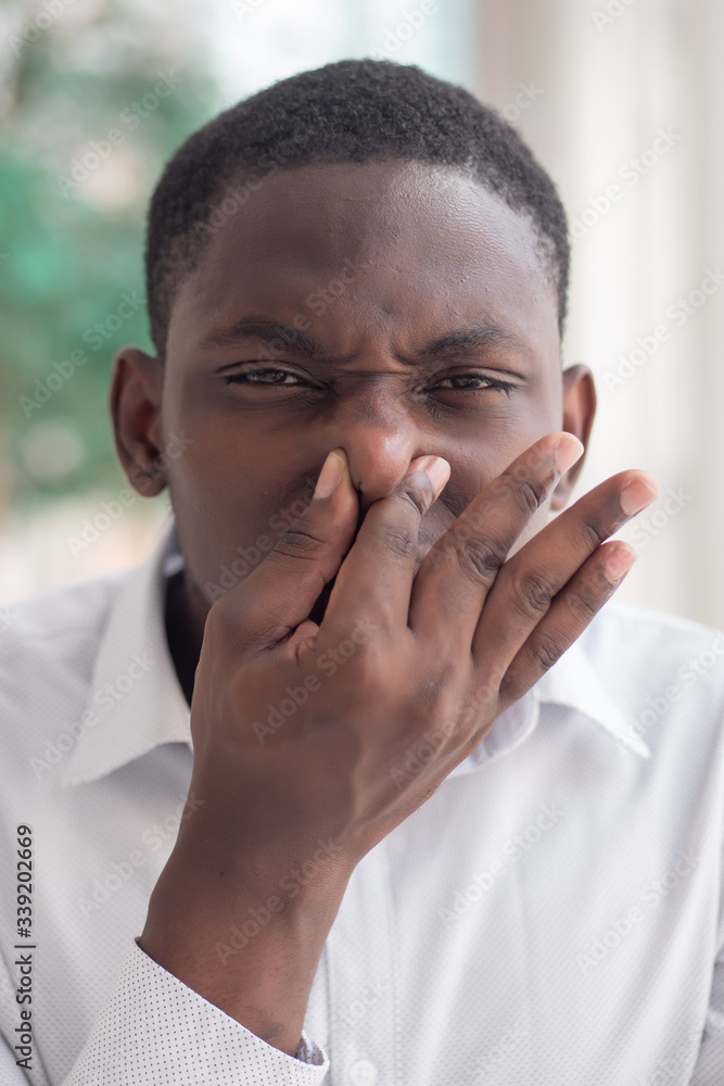 African black man covering his nose for bad smell; African black man ...